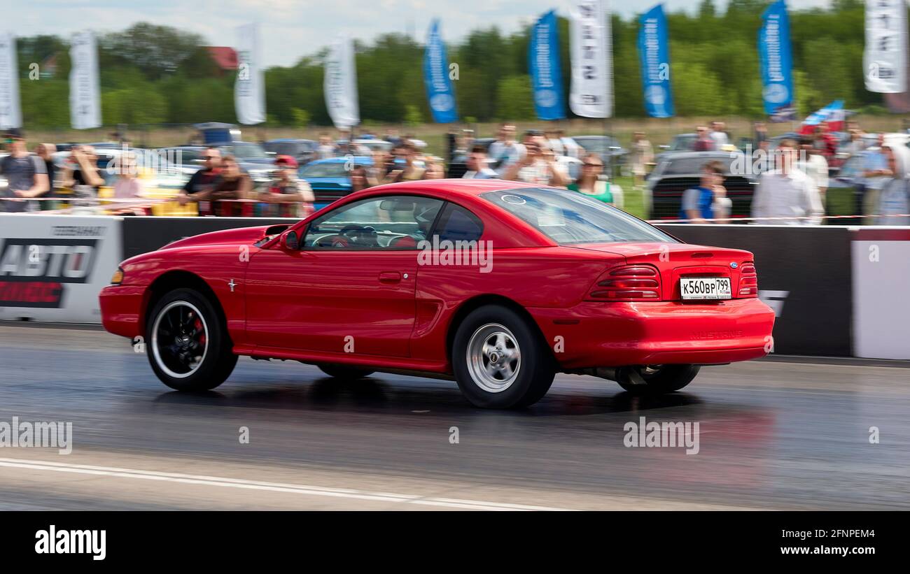 A red sports car passes by the stands, during the event.The annual ...