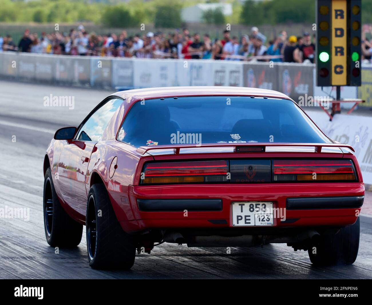 Green traffic light on for a red sports car, during the event. The ...