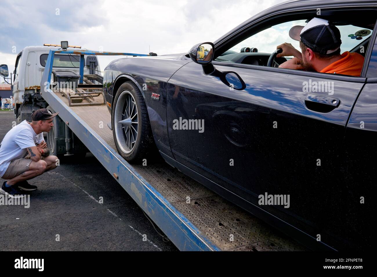 A sports car being evacuated, during the event. The annual classic drag races of American retro ...