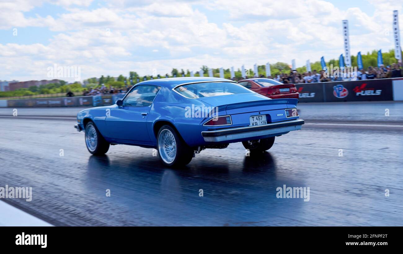 Moscow, Russia. 16th May, 2021. Blue and red muscle cars racing during ...