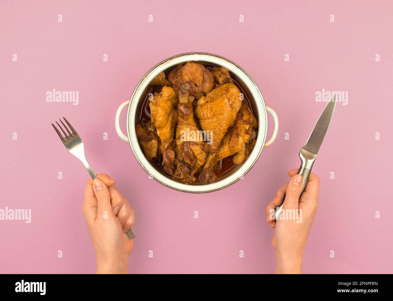 Hungry person with man with fork and knife ready to eat roasted chicken ...