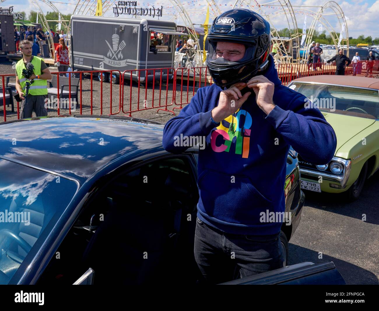 The rider puts on a helmet during the event. The annual classic drag ...