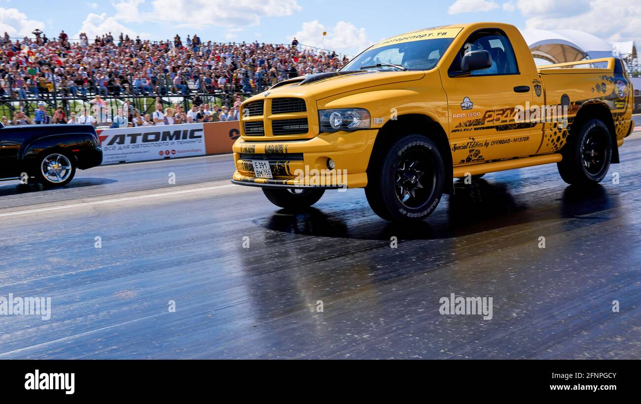 A yellow pick up truck racing during the event. The annual classic drag ...