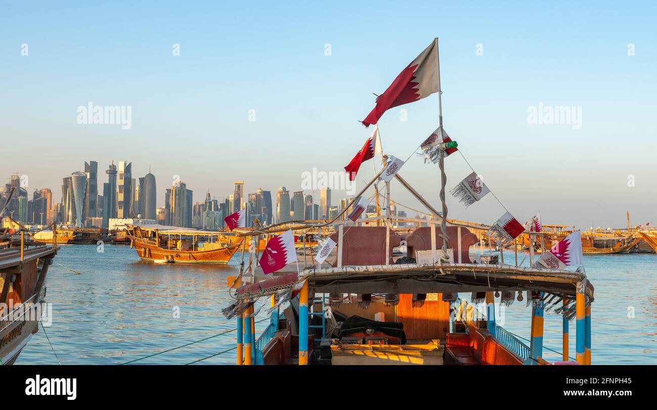 Traditional Arabic Dhow boats along with Doha skyline. Selective focus ...