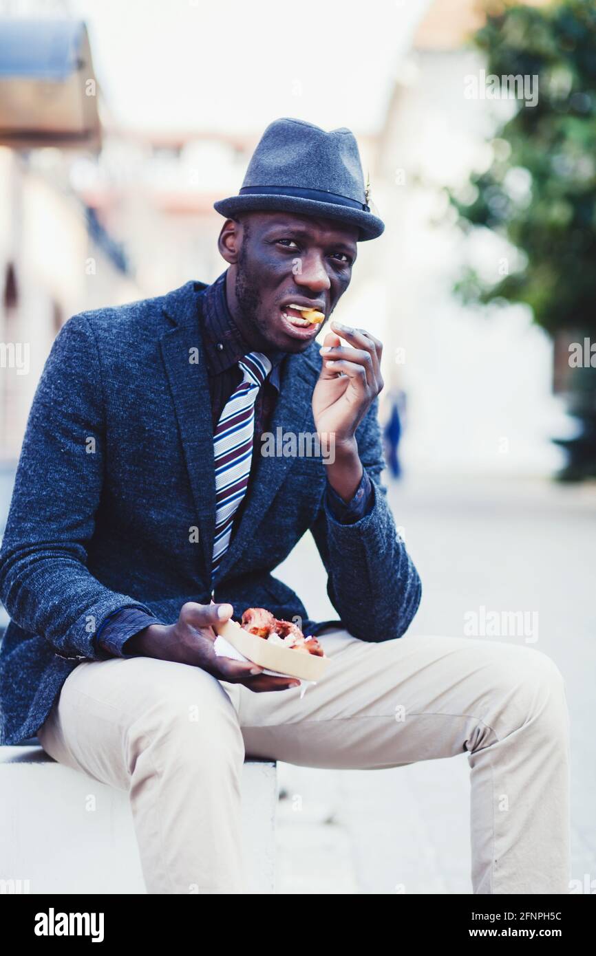 black african man eating street food in town Stock Photo - Alamy