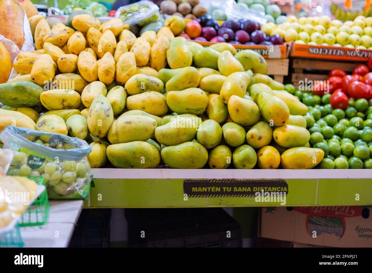 Colorful fruit stand with mangoes, limes, plums, and more Stock Photo ...