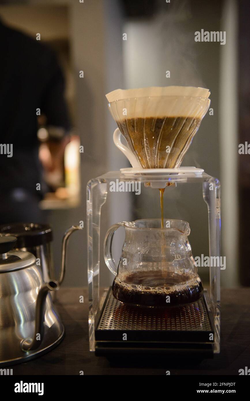 Coffee dripping through filter in coffee shop and steam rising from ...