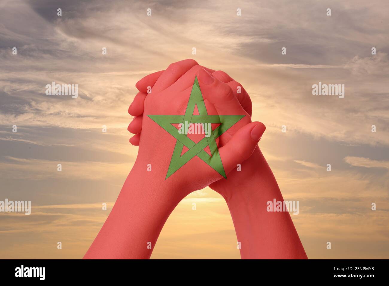 Hands in colors of Moroccan flag at sunrise Stock Photo - Alamy
