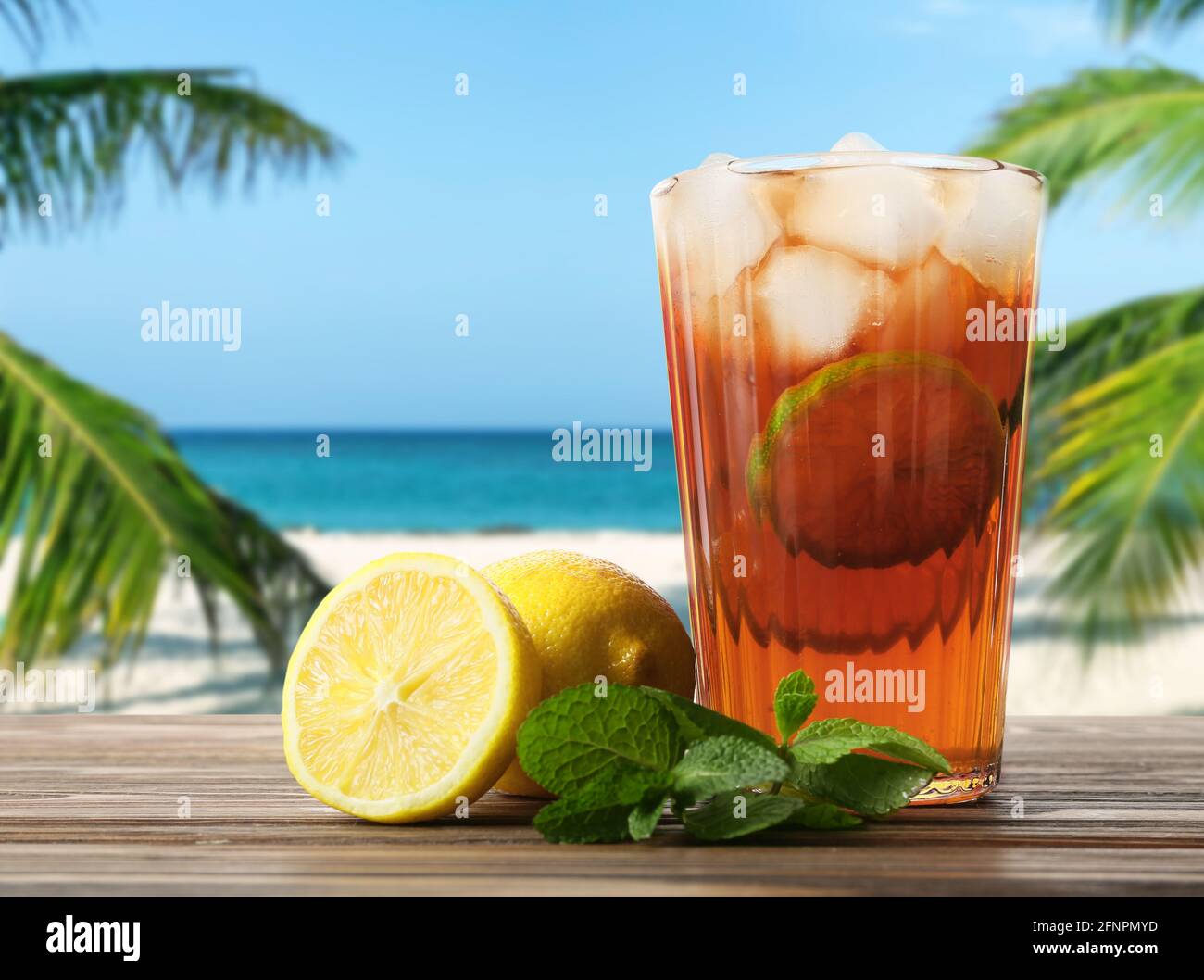 Glass of tasty cold ice tea on table in beach bar Stock Photo - Alamy
