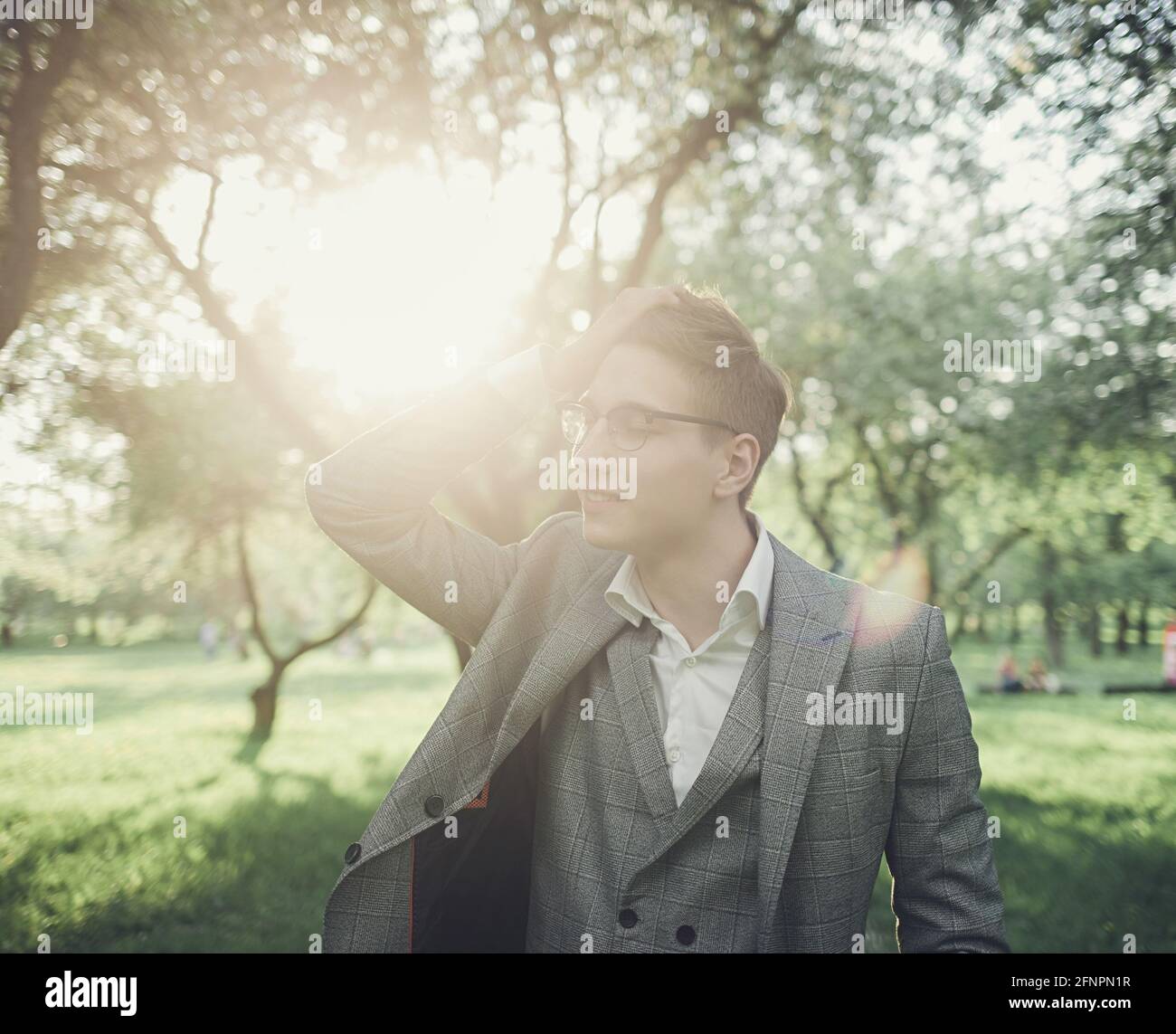 groom is dreamy in glasses posing in wedding day outdoors Stock Photo ...