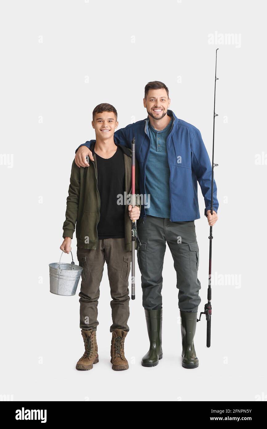 Happy father and son with fishing rods and bucket on white background ...