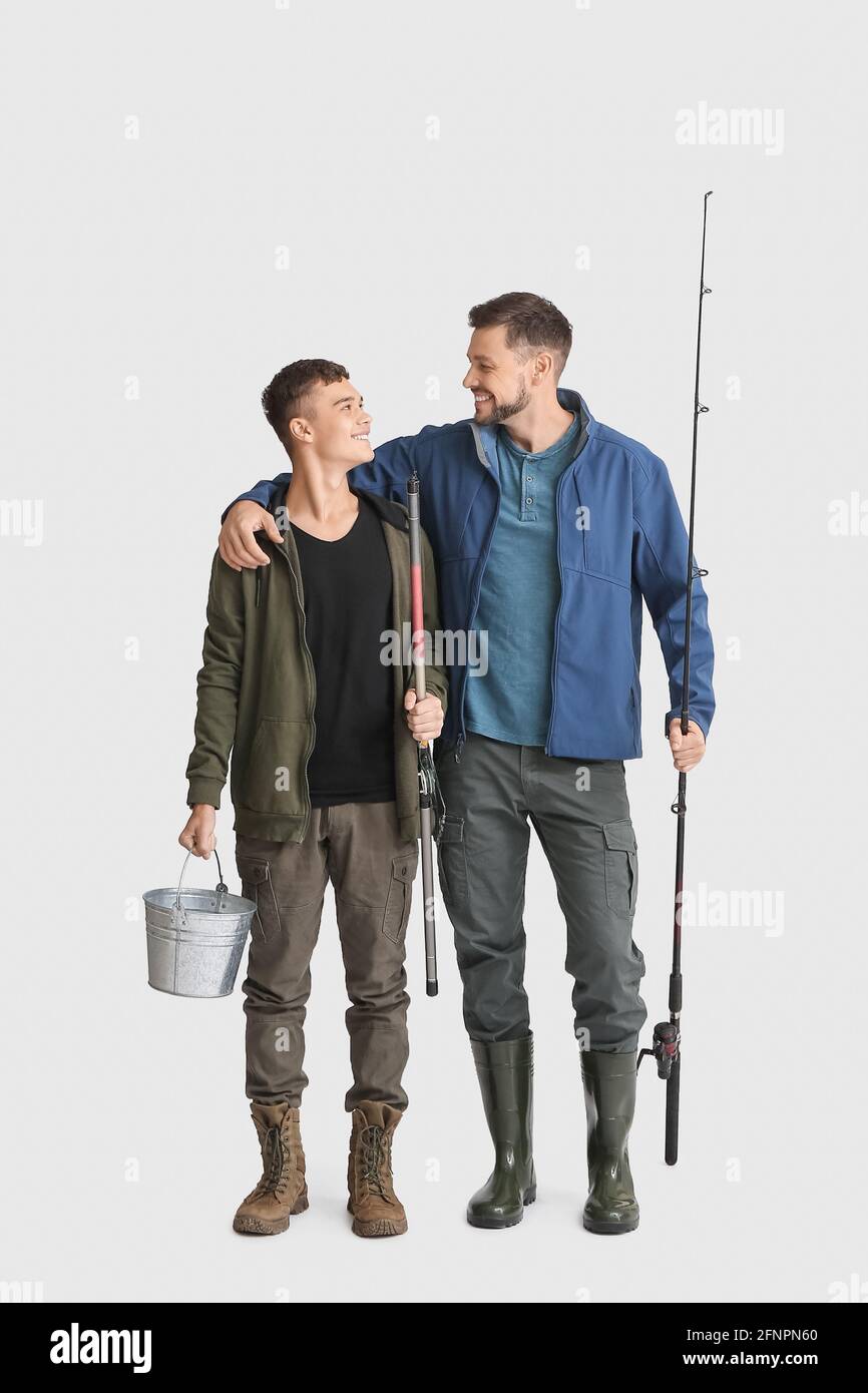 Happy father and son with fishing rods and bucket on white background ...