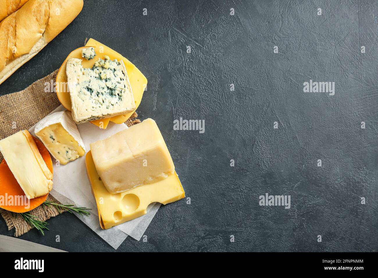 Different types of cheese and fresh bread on dark background Stock ...