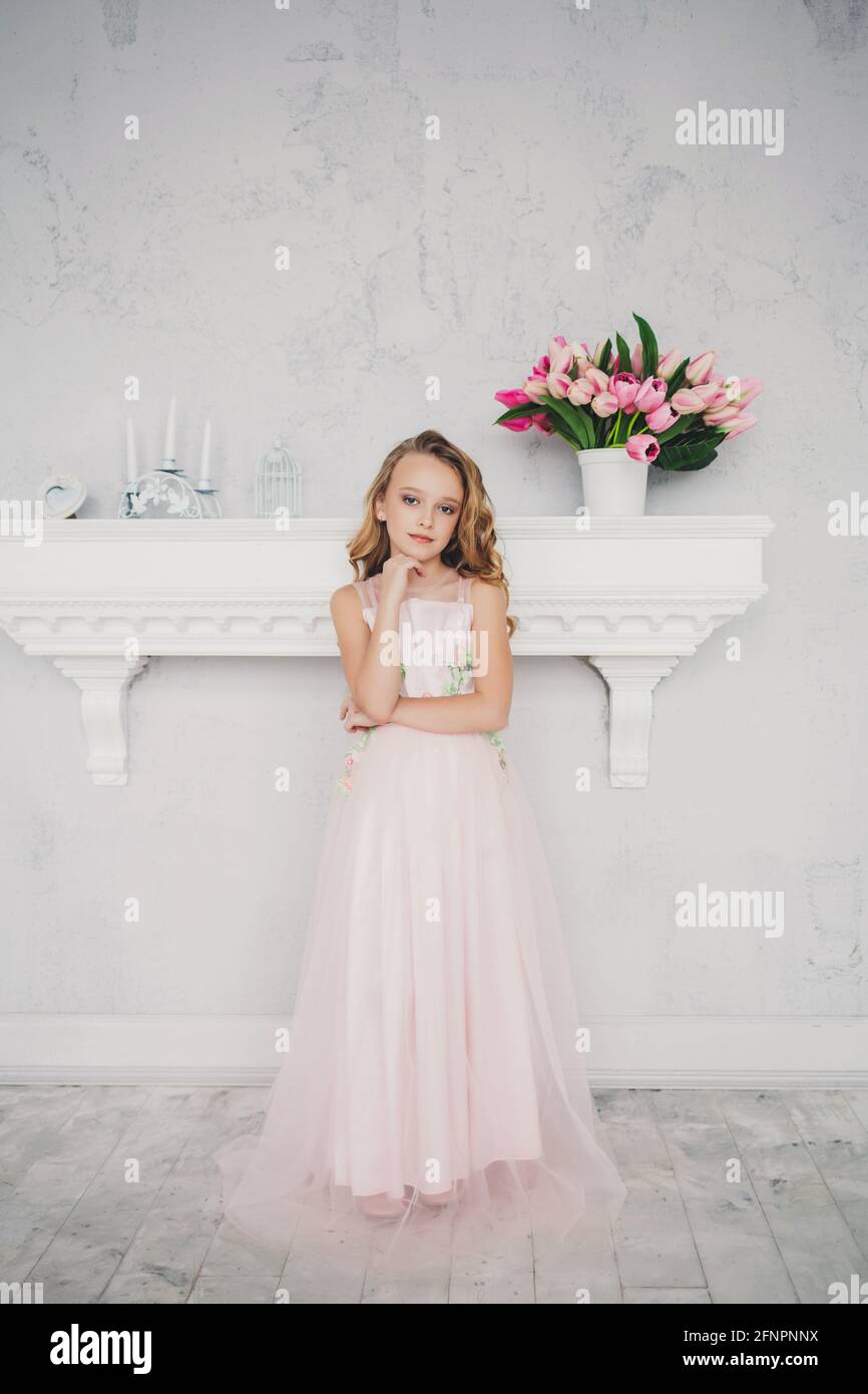 Happy cute little girl in dress posing in studio Stock Photo - Alamy
