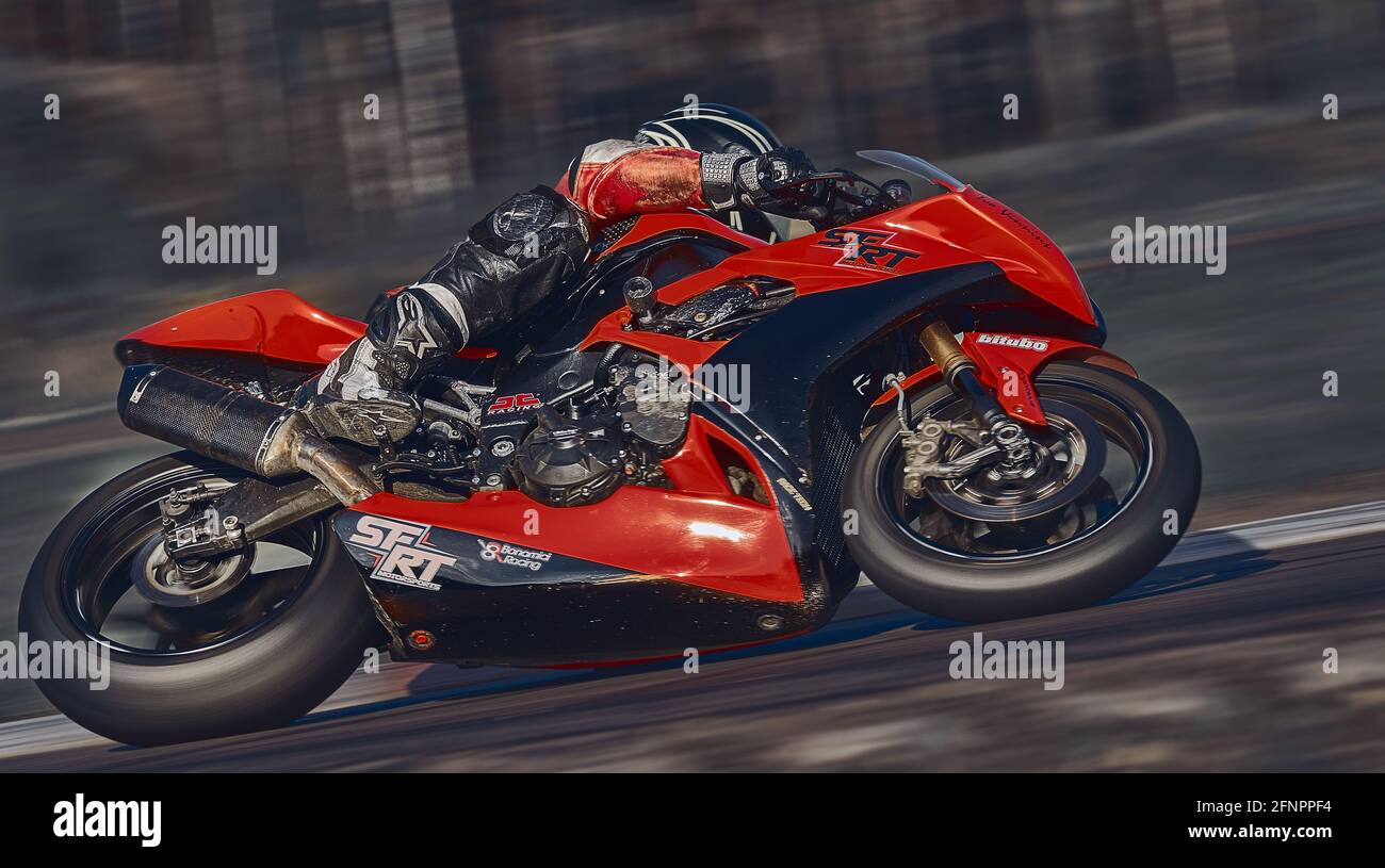 Motorcycle moving very fast along motion blurred road Stock Photo - Alamy