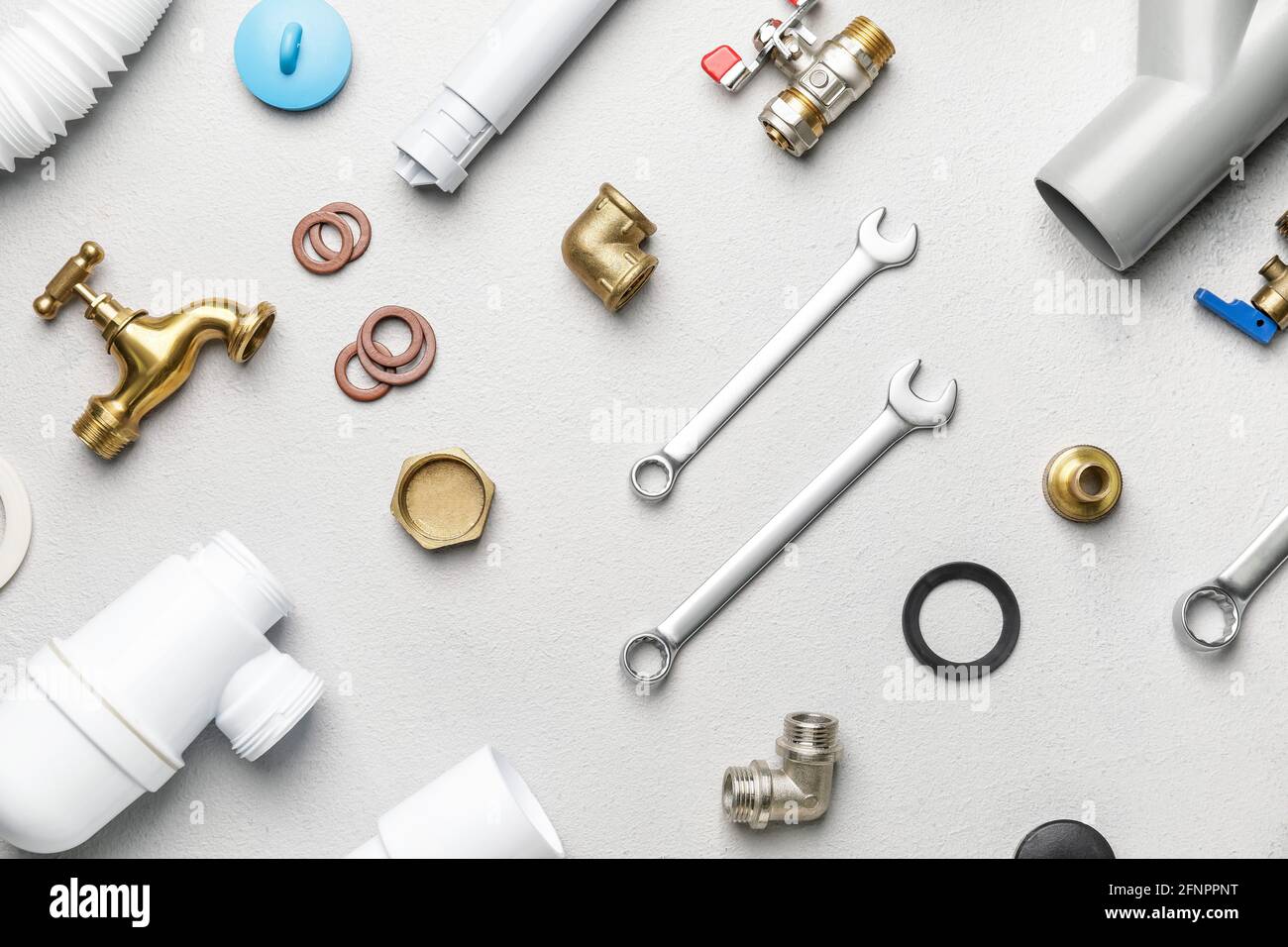 Set of plumber's items on light background Stock Photo - Alamy
