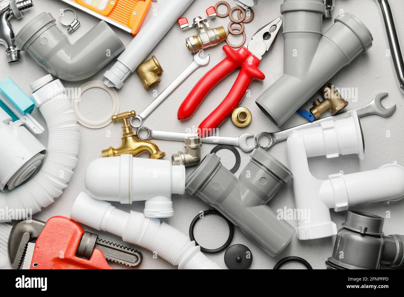 Set of plumber's items on light background Stock Photo - Alamy