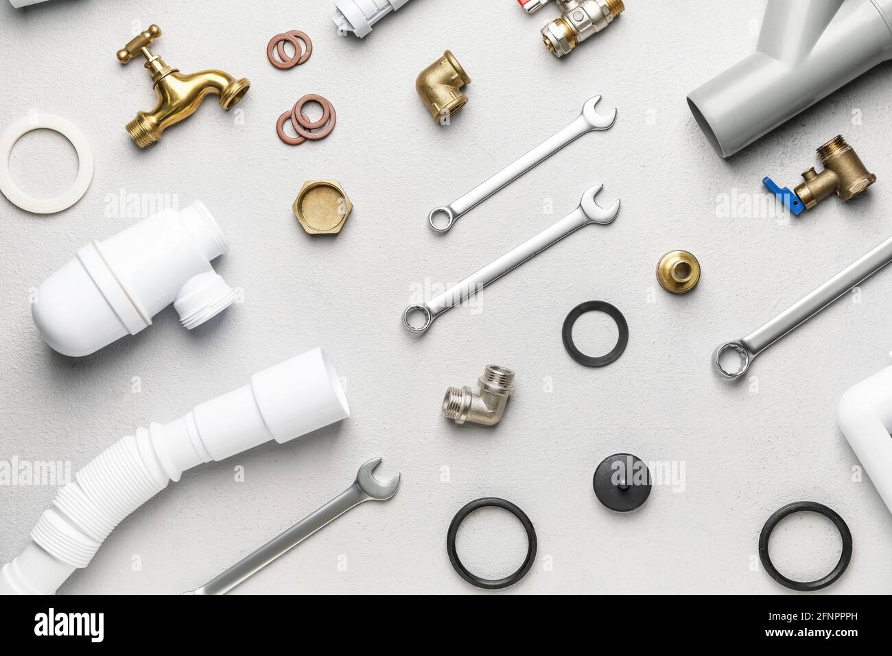 Set of plumber's items on light background Stock Photo - Alamy