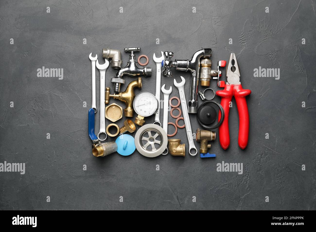 Set of plumber's items on dark background Stock Photo - Alamy