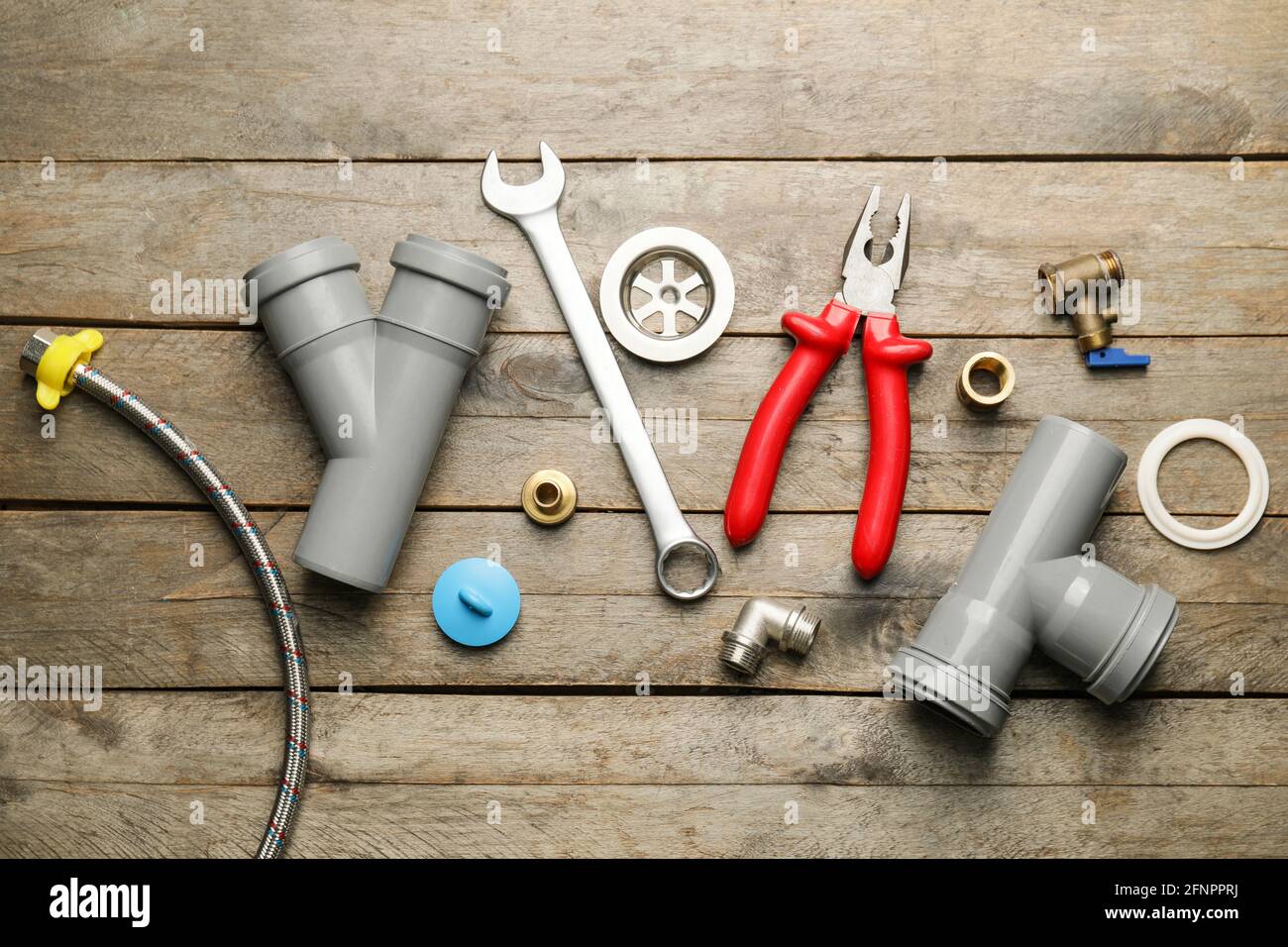 Set of plumber's items on wooden background Stock Photo - Alamy