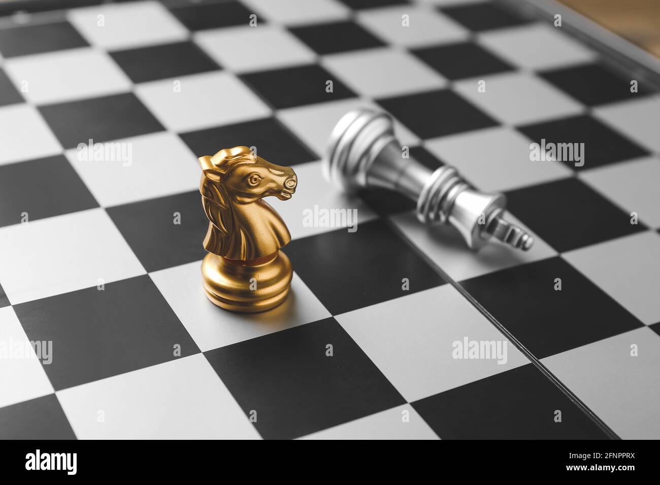 Knight and king on chess board Stock Photo - Alamy