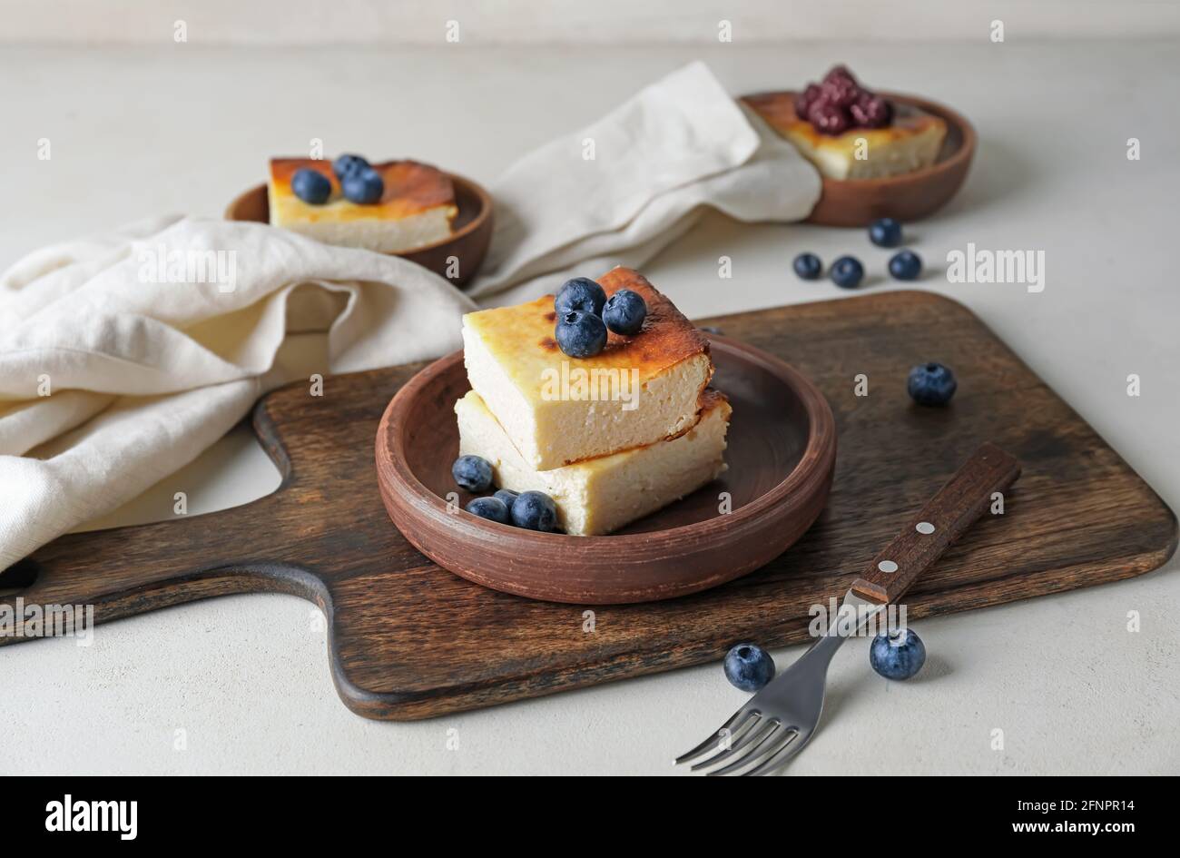 Plate with pieces of cottage cheese casserole on table Stock Photo - Alamy