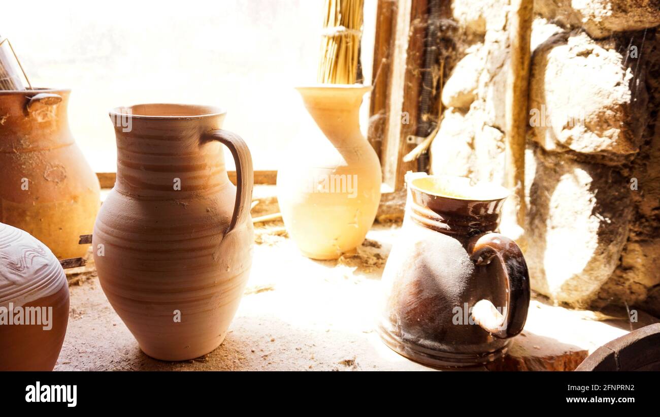 Old clay pot in an old room. Old dusty shelves in a pottery workshop ...