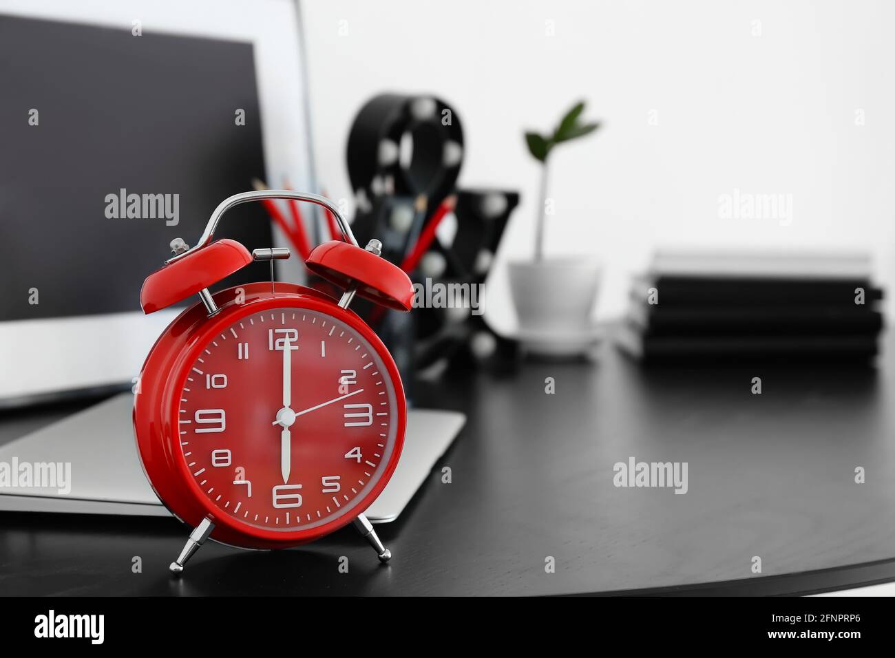 Alarm clock on table in room Stock Photo - Alamy
