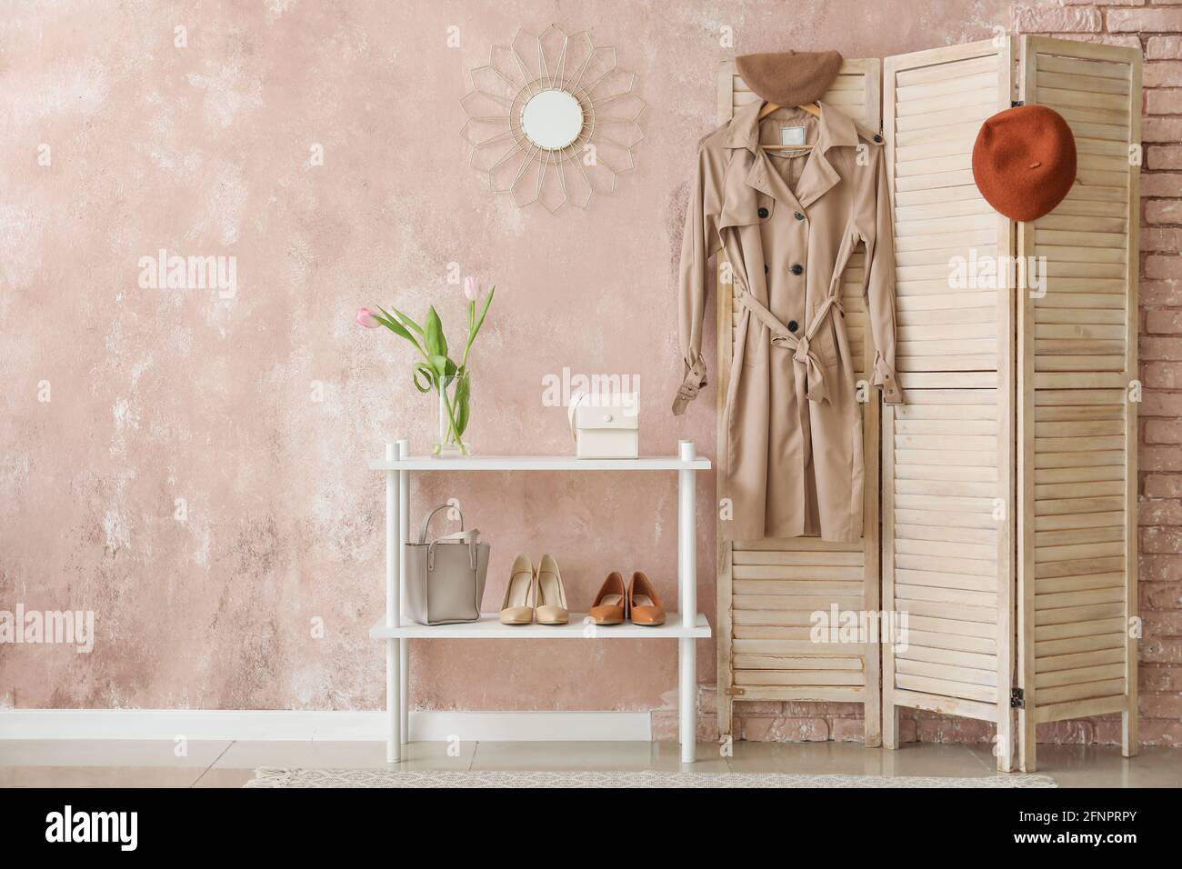 Interior of stylish hallway with folding screen Stock Photo - Alamy