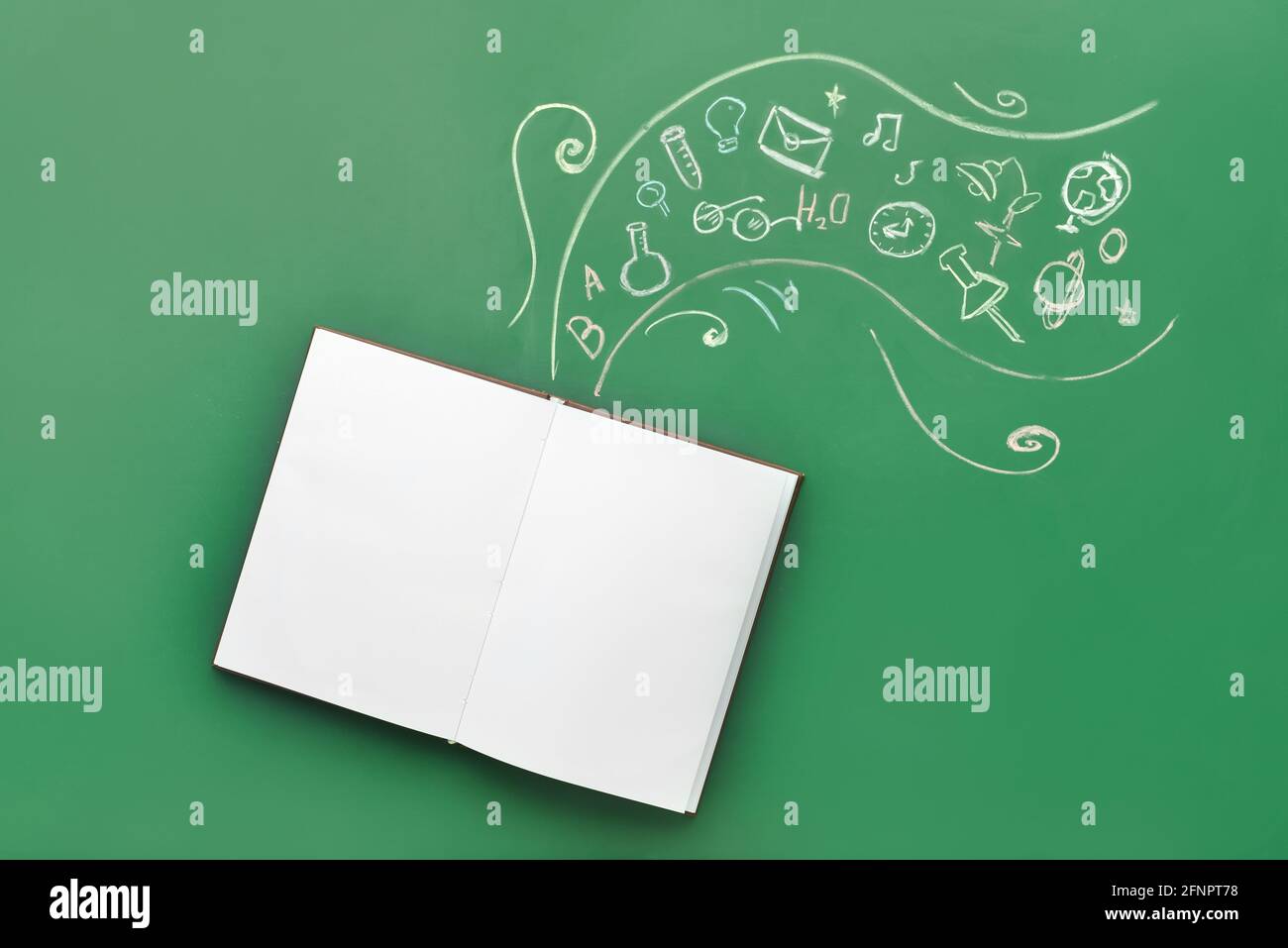 Open book and drawings on color background Stock Photo - Alamy