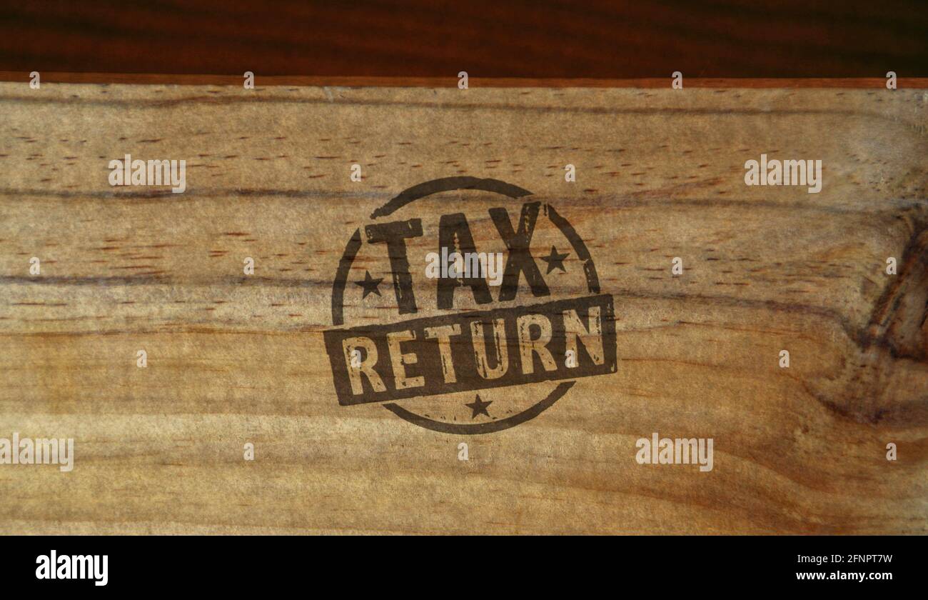 Tax return stamp printed on wooden box. Taxation refund, financial ...