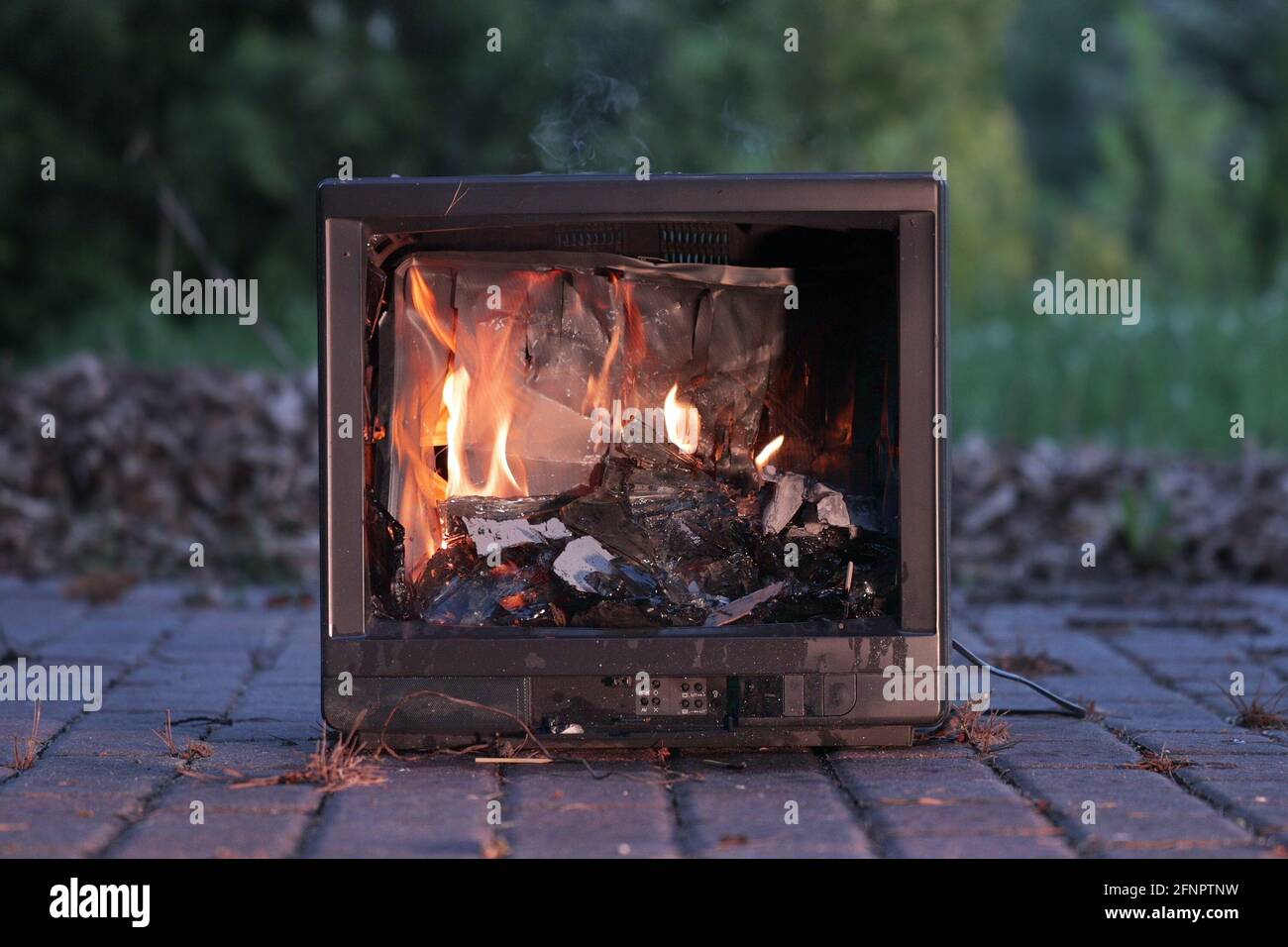TV burning with broken screen Stock Photo - Alamy