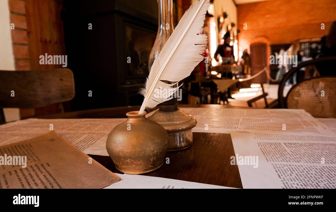 White quill and inkwell in the old university auditorium. There are ...
