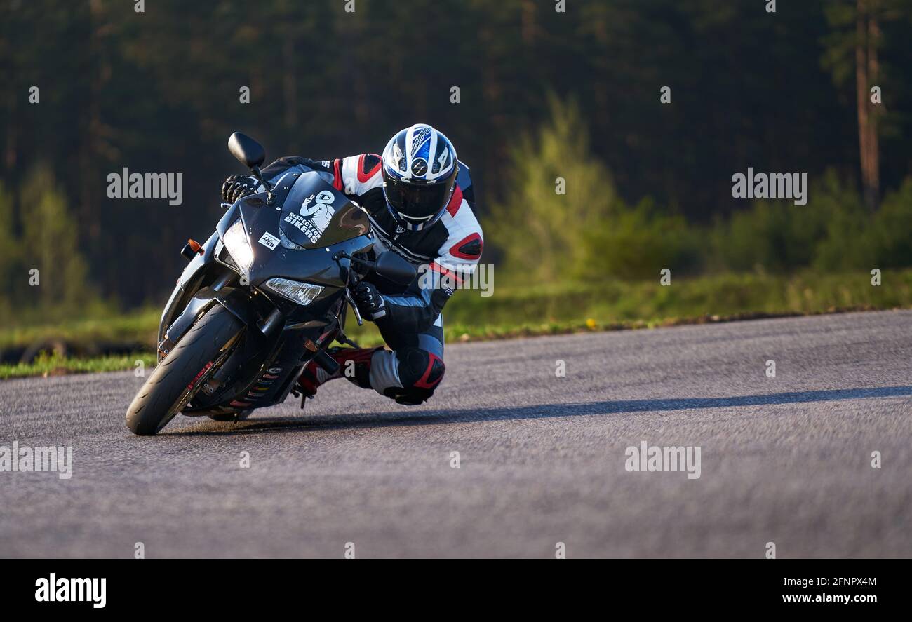 man riding motorcycle in asphalt road Stock Photo - Alamy