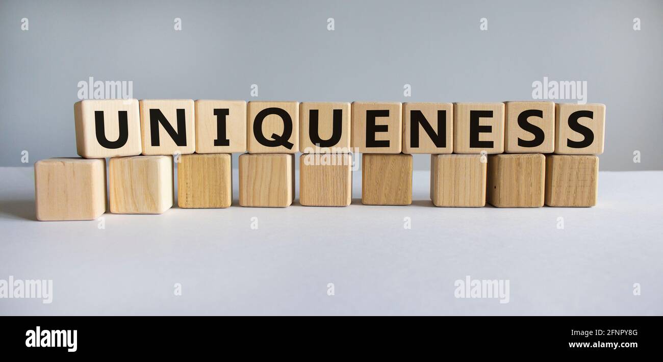 Inclusiveness and uniqueness symbol. Wooden cubes with the word ...