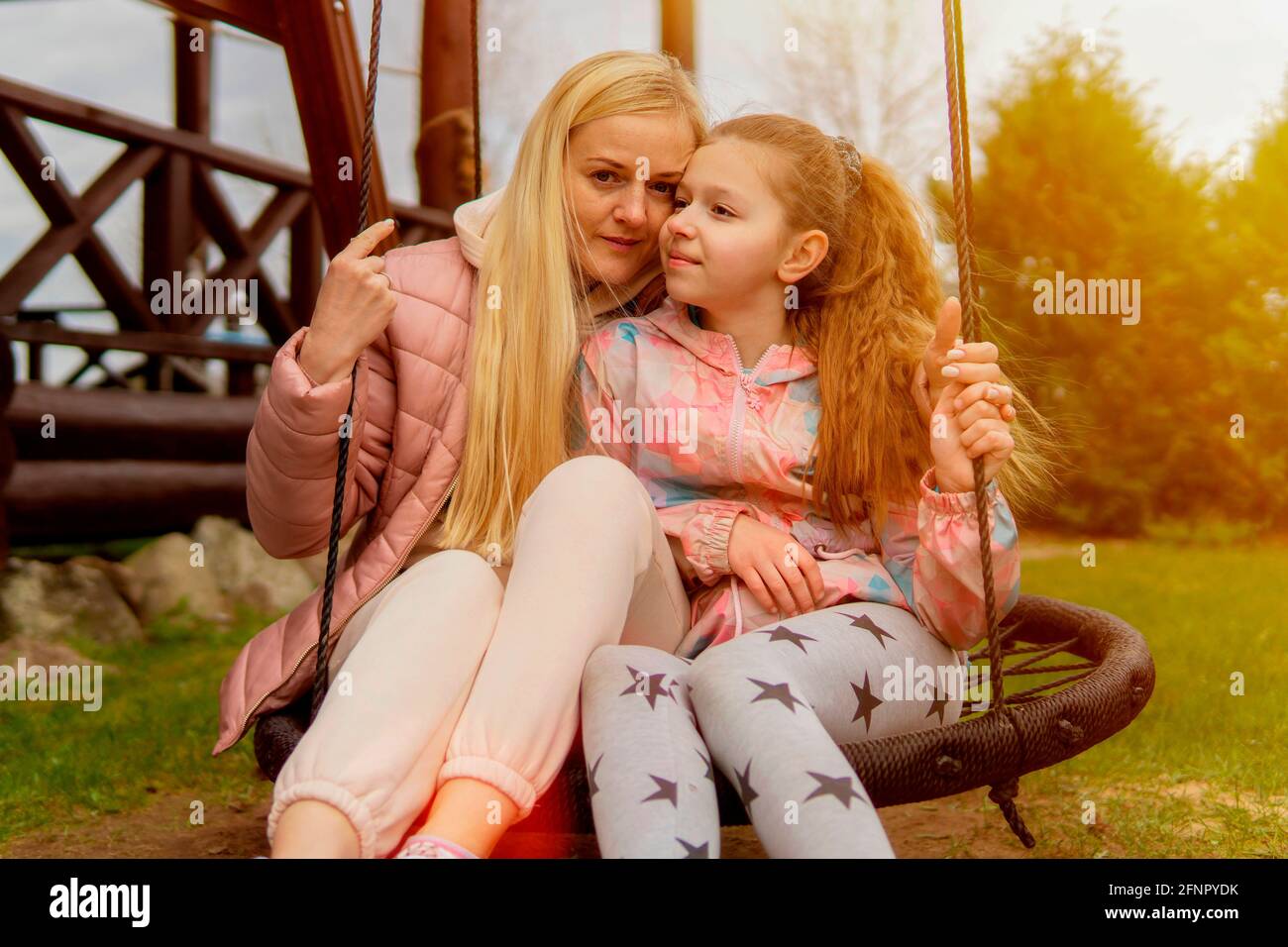 Mother and daughter ride seesaw together Stock Photo - Alamy