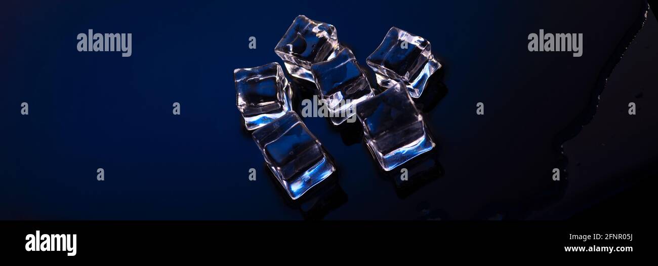 Wet ice cubes on blue background top view Stock Photo - Alamy