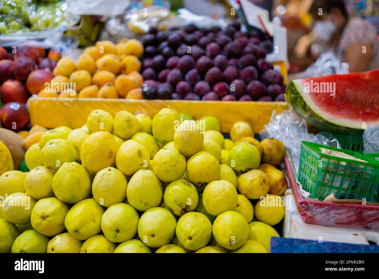 Colorful fruit stand with guavas, mangoes, peaches, and more Stock ...