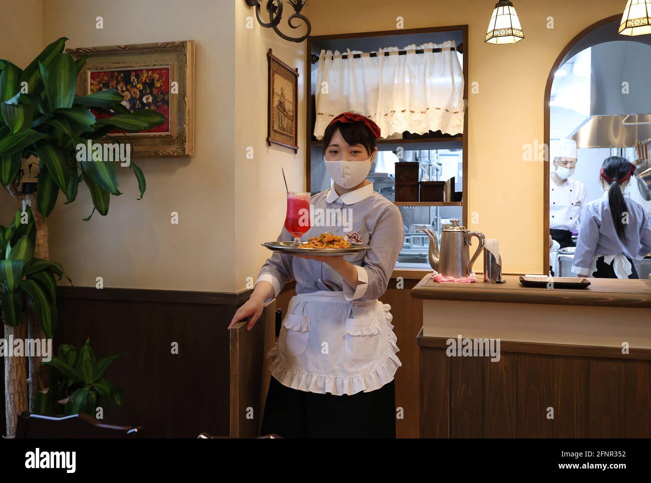 Tokorozawa, Japan. 18th May, 2021. An actress performs as a waitress ...