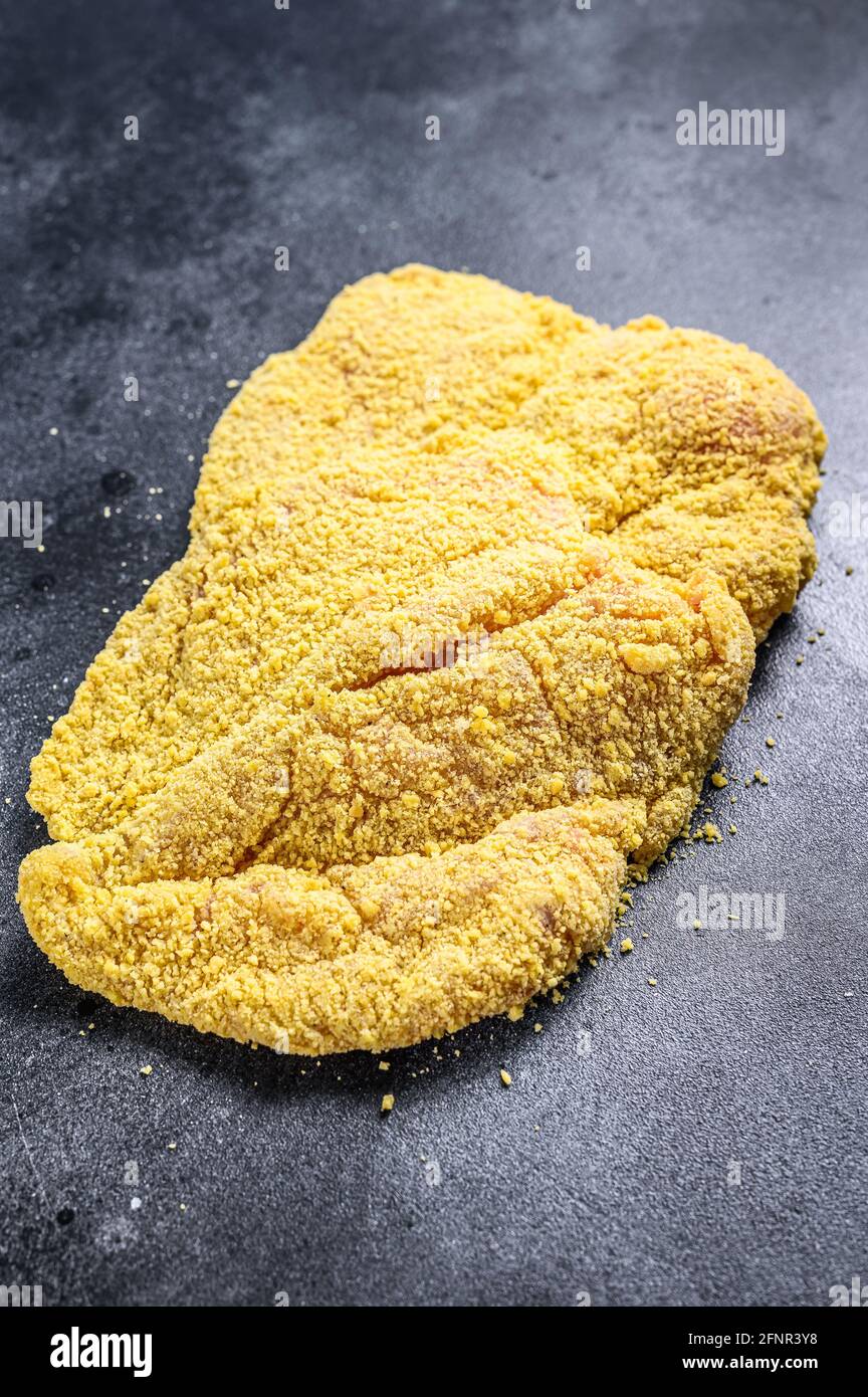 Raw Homemade Breaded German Weiner Schnitzel. Black background. Top ...