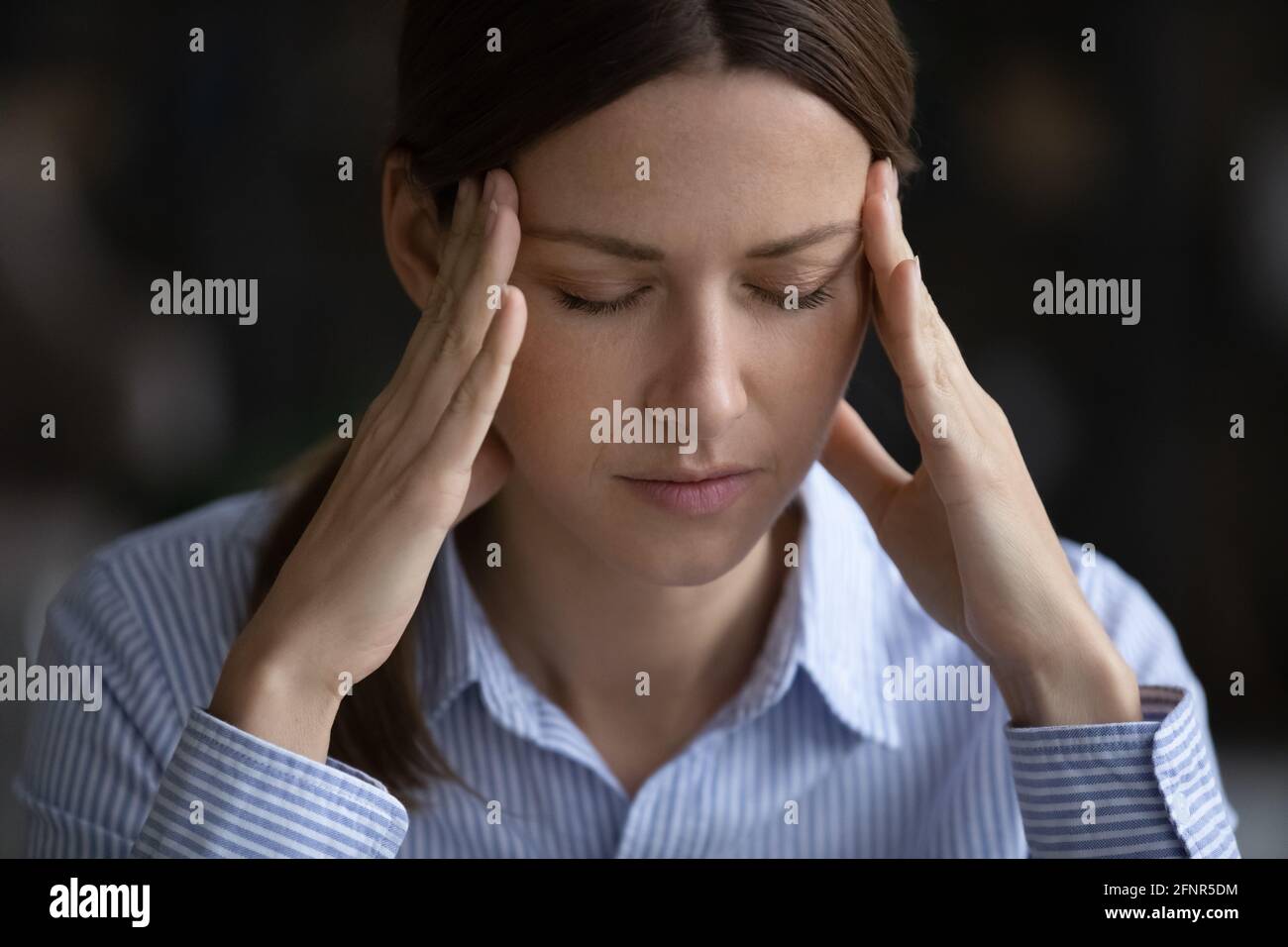 Rubbing her temples hi-res stock photography and images - Alamy