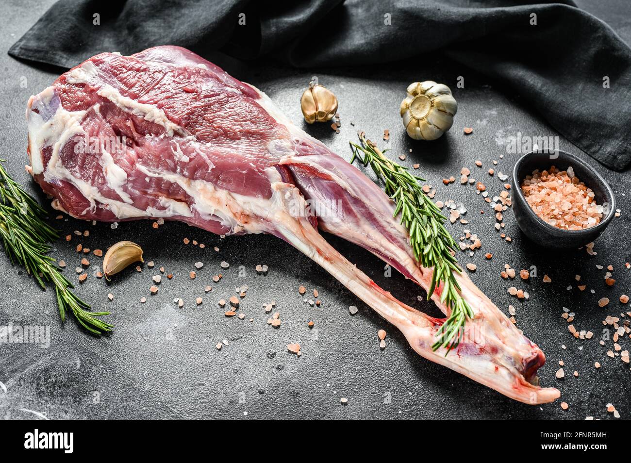 Whole lamb leg. Raw organic meat. Black background. Top view Stock ...