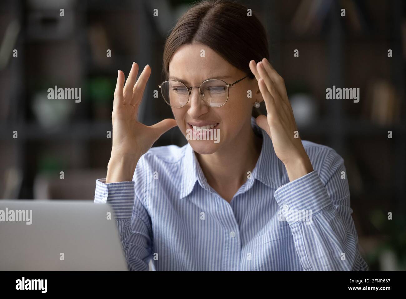 Angry young woman worker look at laptop screen making mistake Stock ...