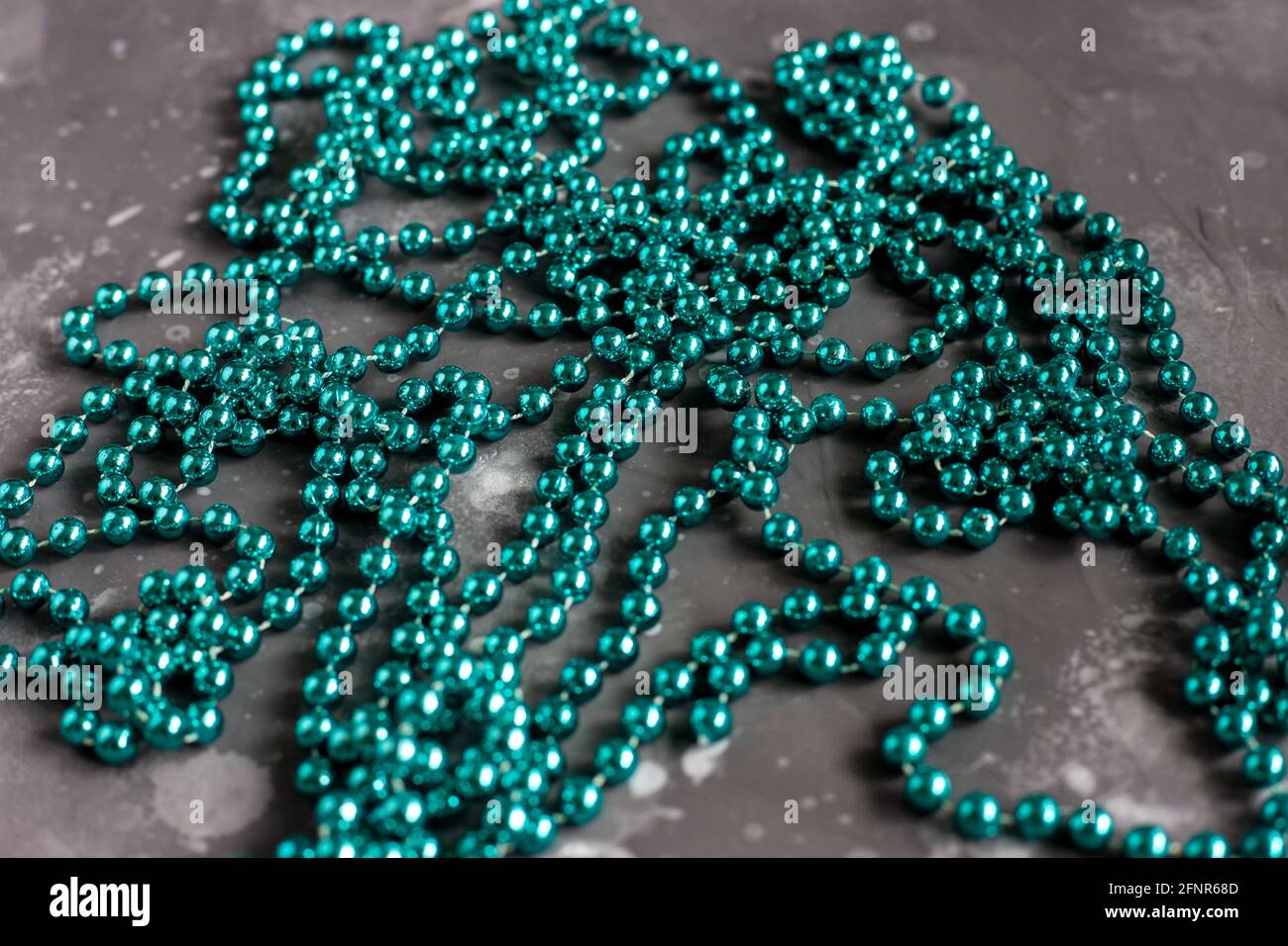 Long turquoise beads from lie on a gray surface Stock Photo - Alamy