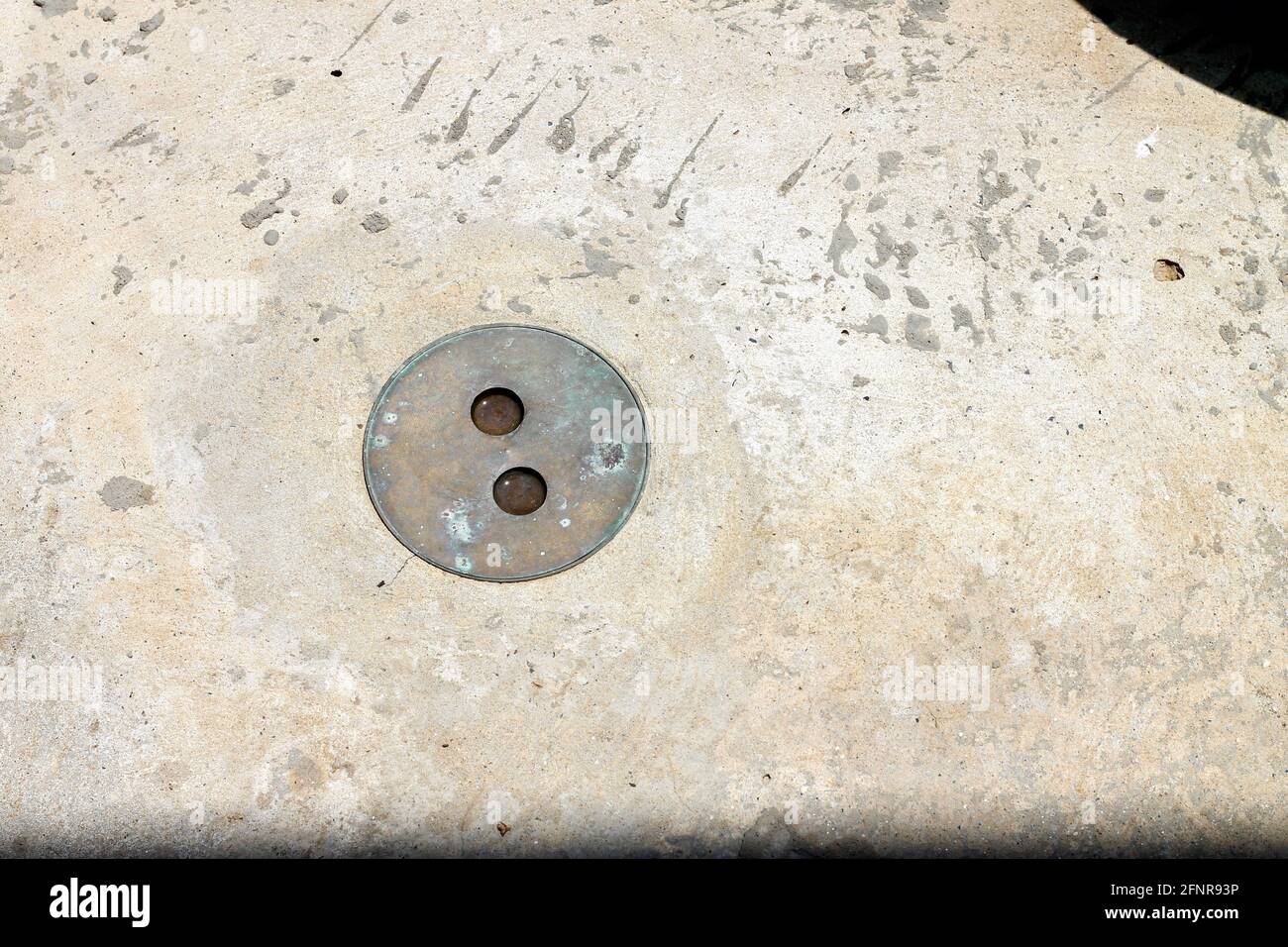The circular brass manhole cover has been rusted Stock Photo - Alamy