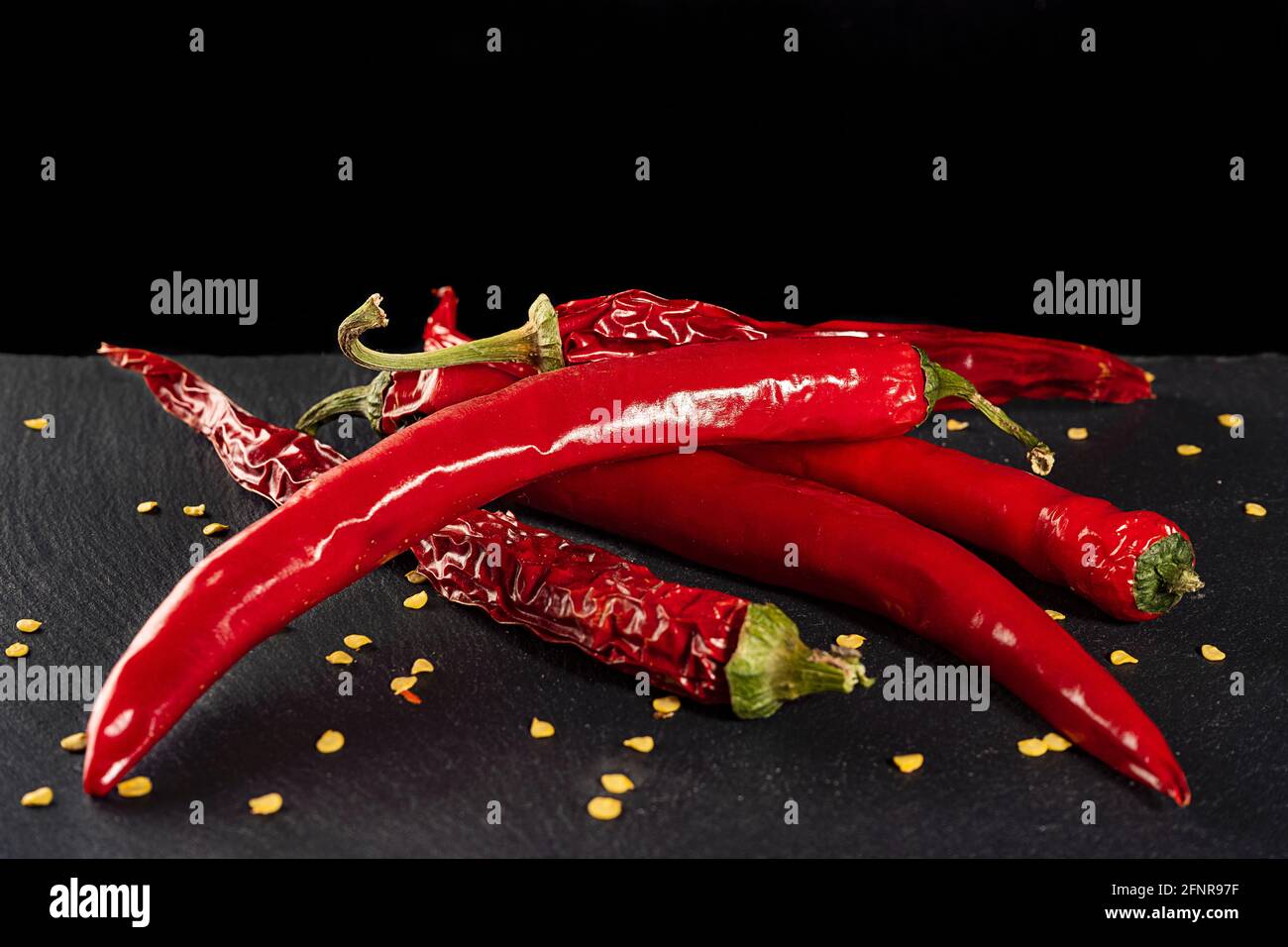 Red pepper pods on a black background. Ready for consumption. Spicy ...