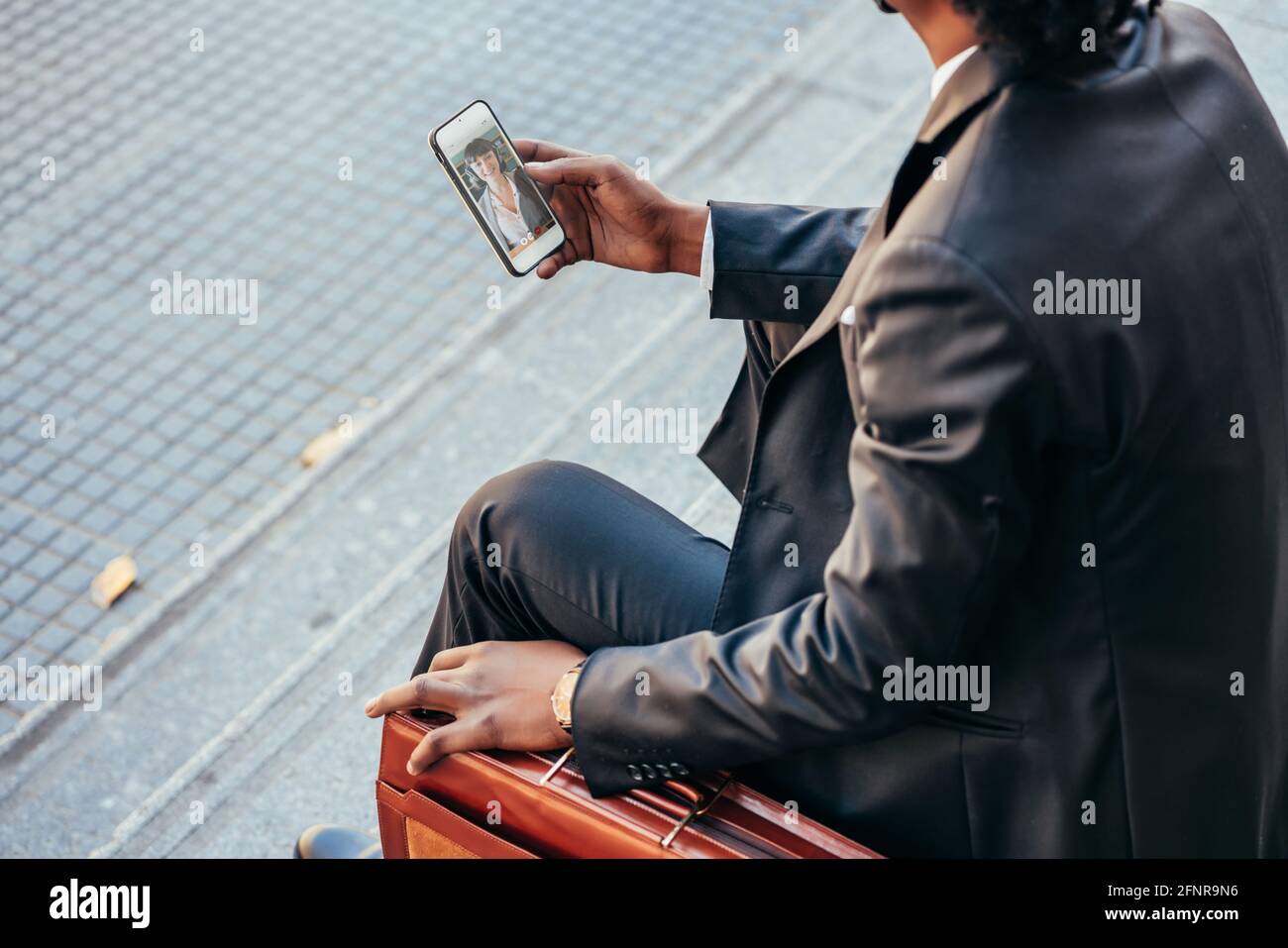Businessman using his mobile phone outdoors Stock Photo - Alamy