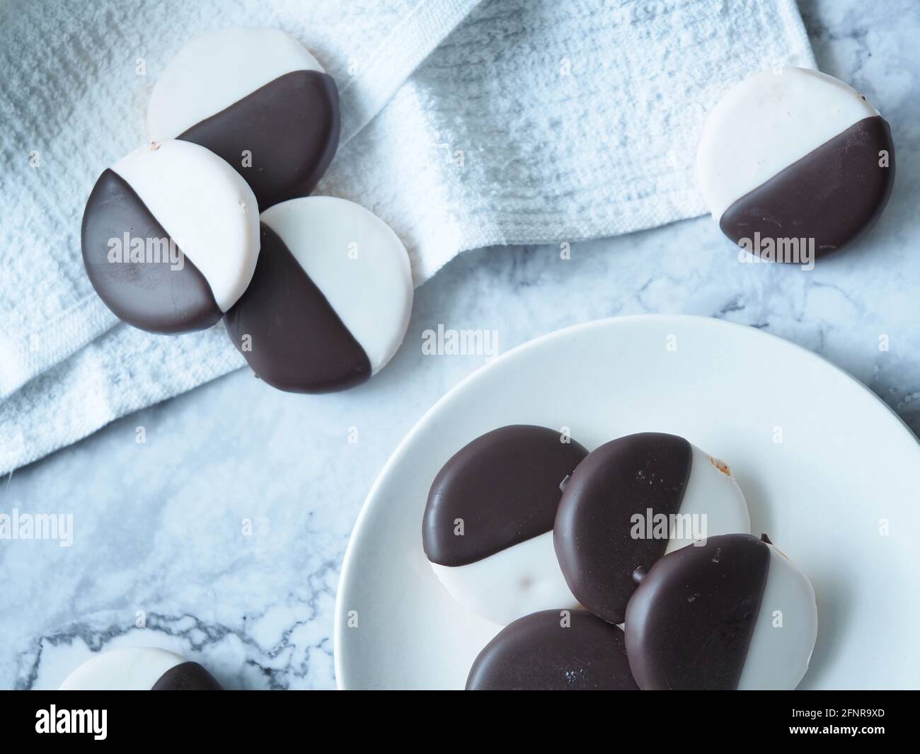 Flat lay of Black and White cookies saucer dish with props Stock Photo ...