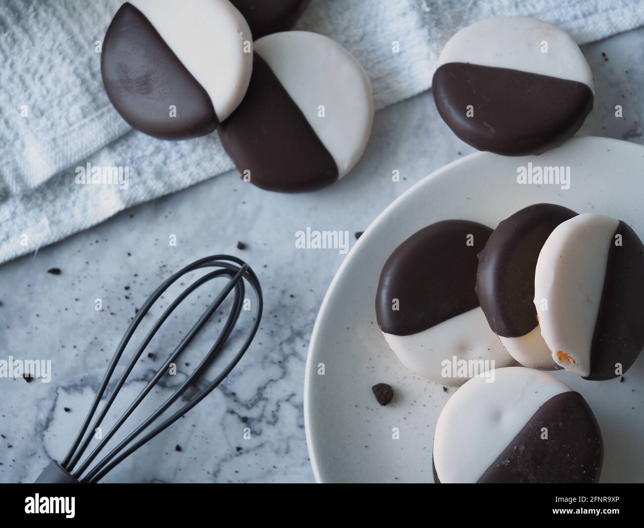 Flat lay of Black and White cookies saucer dish with props Stock Photo ...
