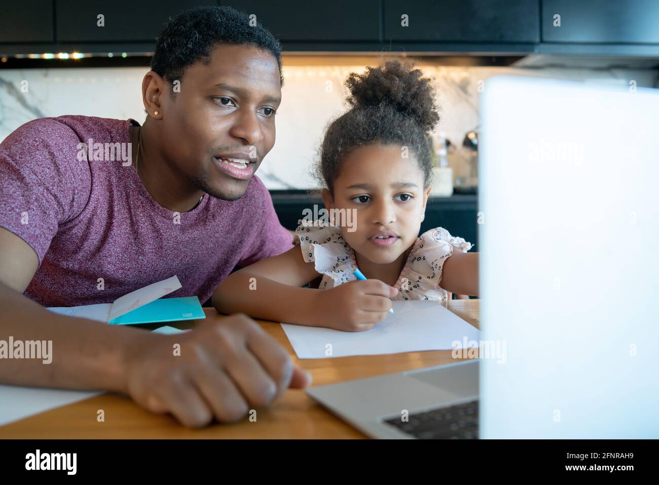 A father helping his daughter with homeschool Stock Photo - Alamy